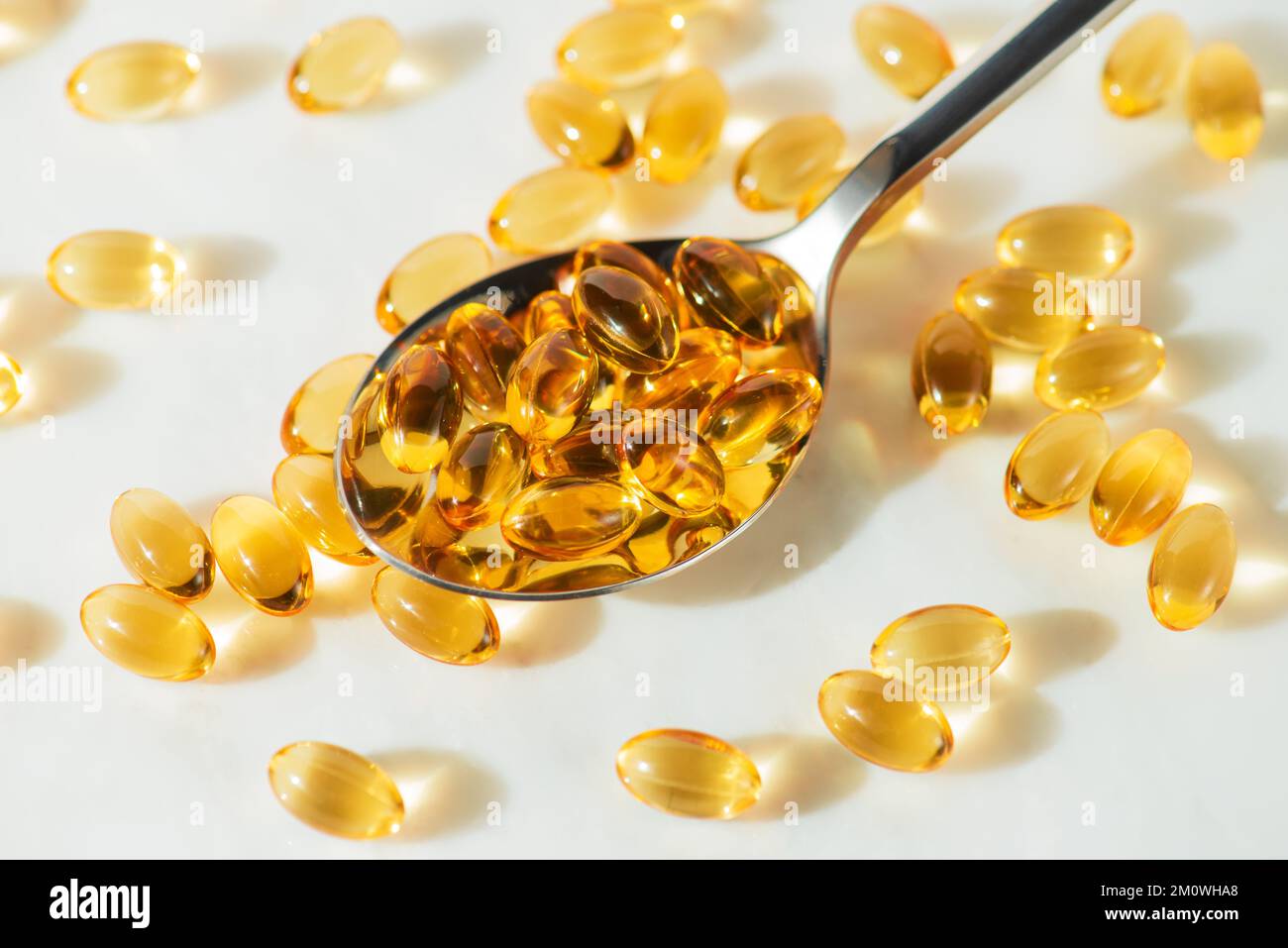 Food supplement Omega 3 in a metal spoon, medical supplements, and ...