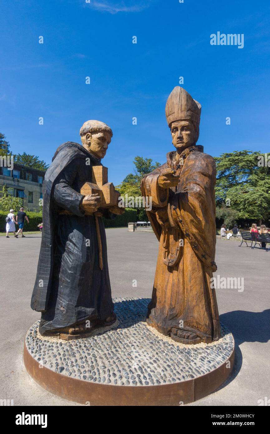 Wooden carvings of an Abbot holding a Cathedral and a Canon ...