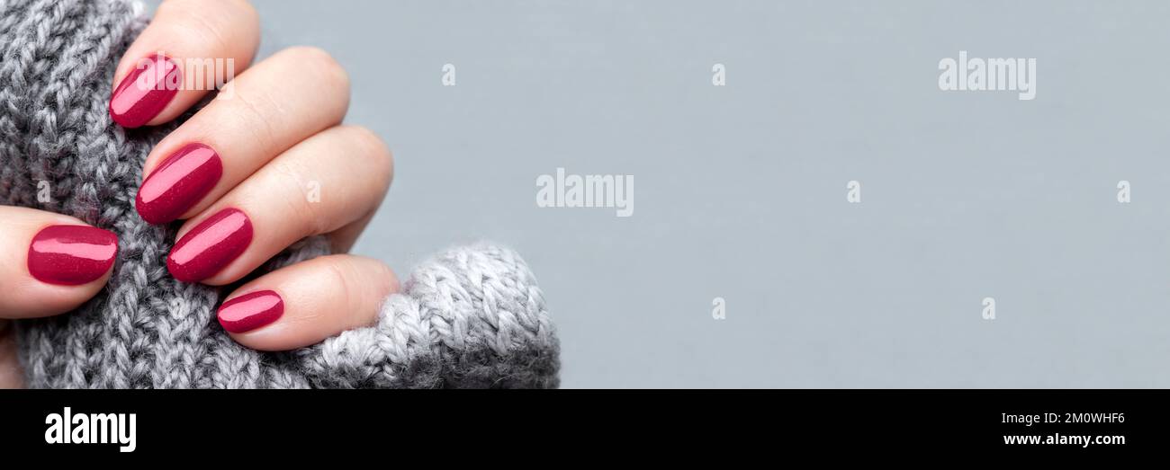 Female hand with knitted scarf and beautiful manicure - viva magenta ...