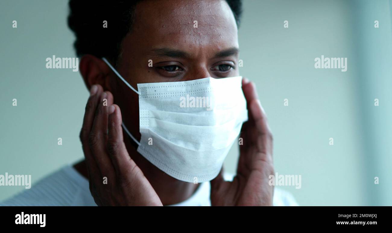 African american wearing and adjusting mask against coronavirus Stock ...
