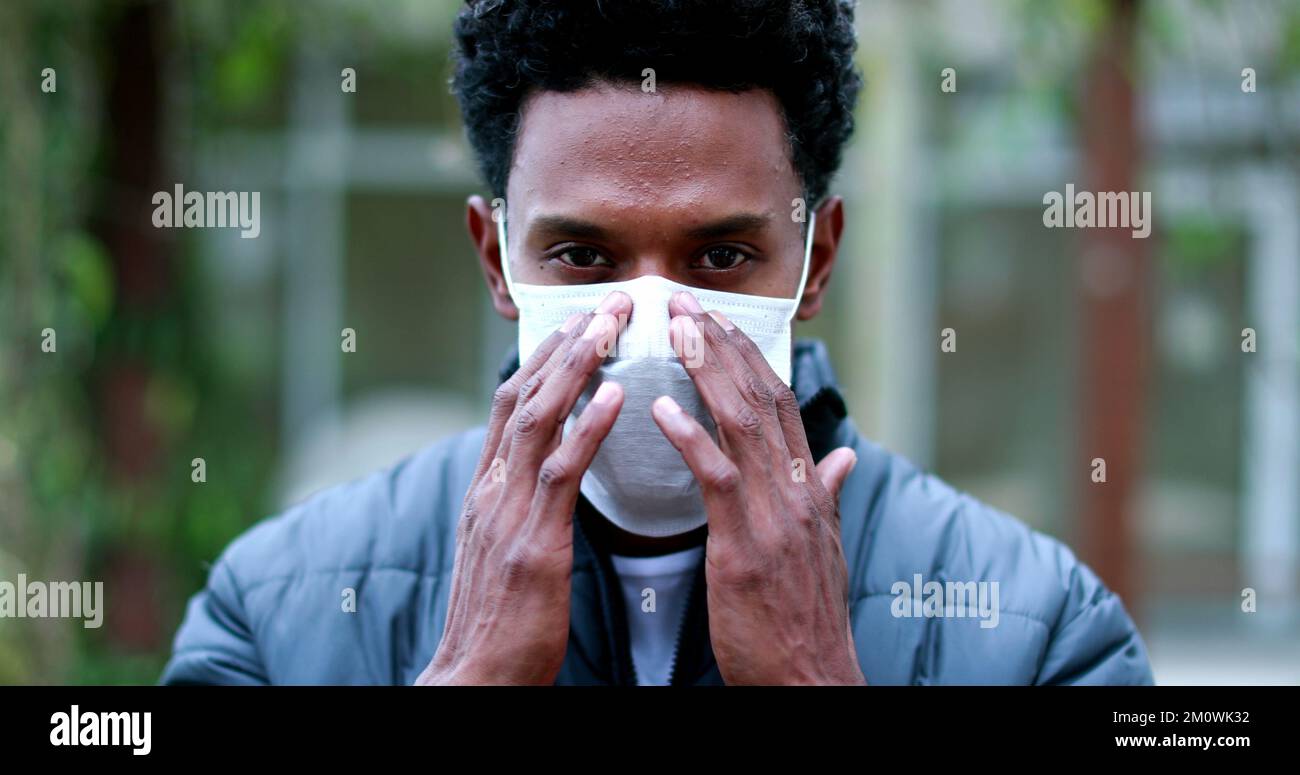 African man putting on covid hi-res stock photography and images - Alamy