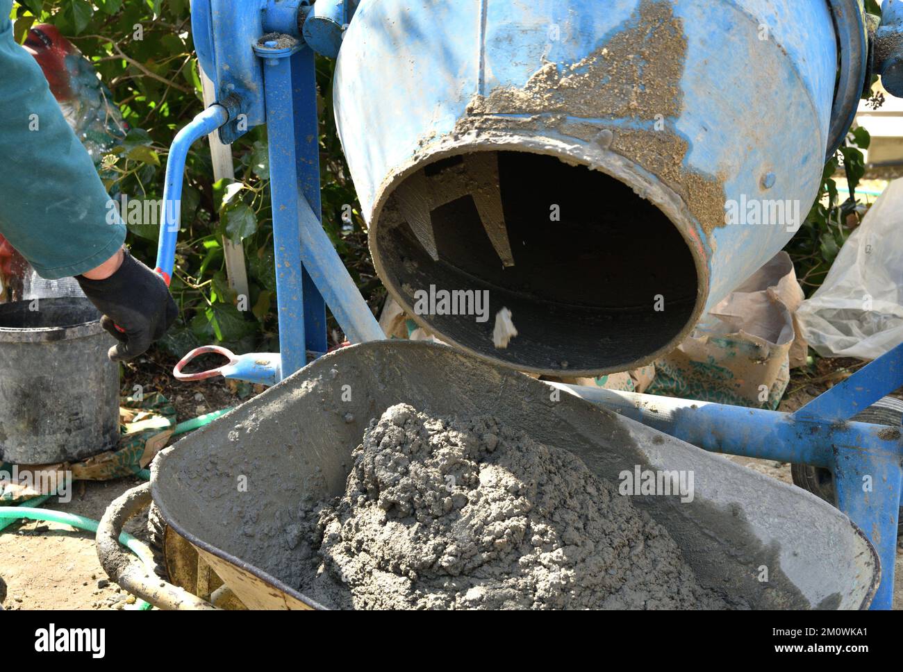 A Mason makes concrete using a concrete temperer traditionally Stock ...