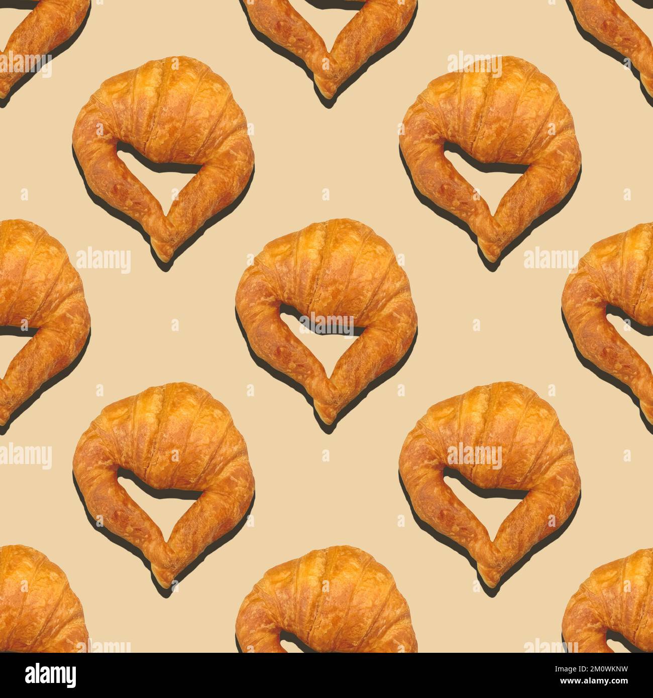 Seamless croissant pattern on cream background Stock Photo - Alamy