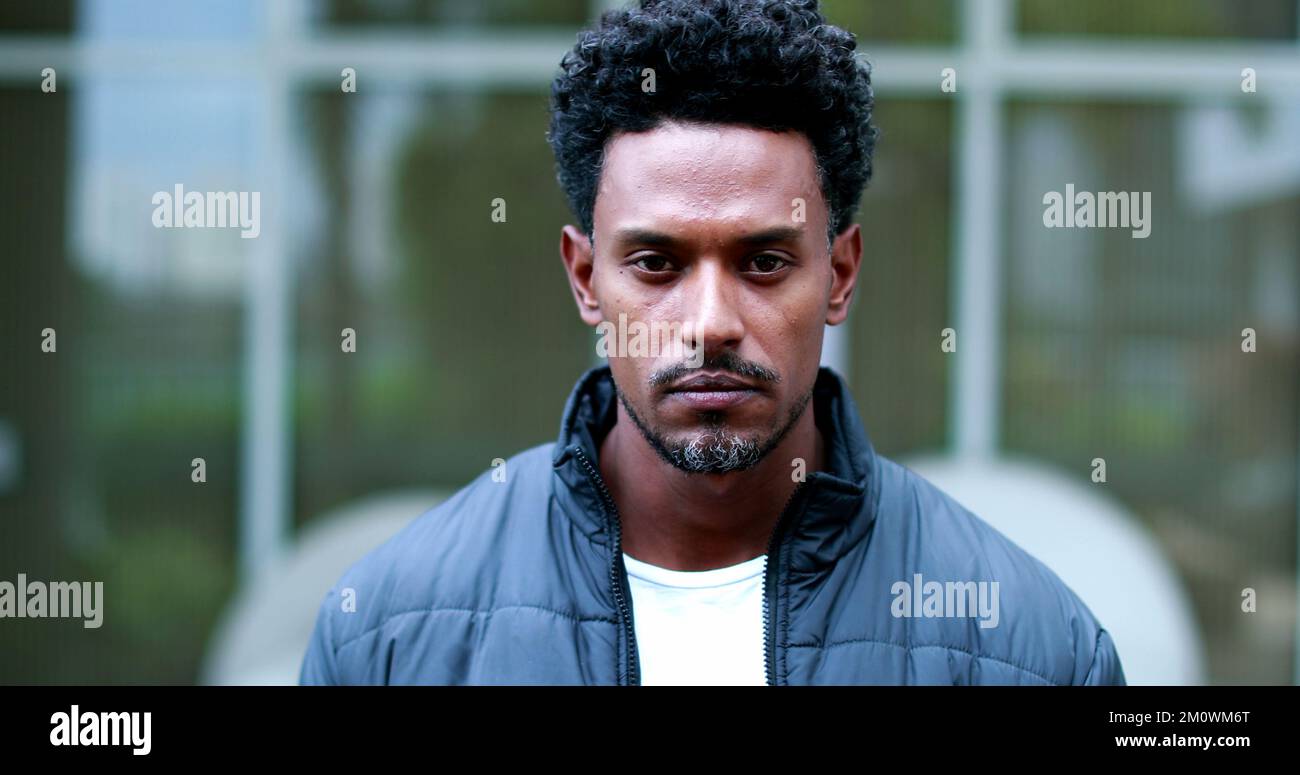 Confident black person walking towards camera Stock Photo - Alamy