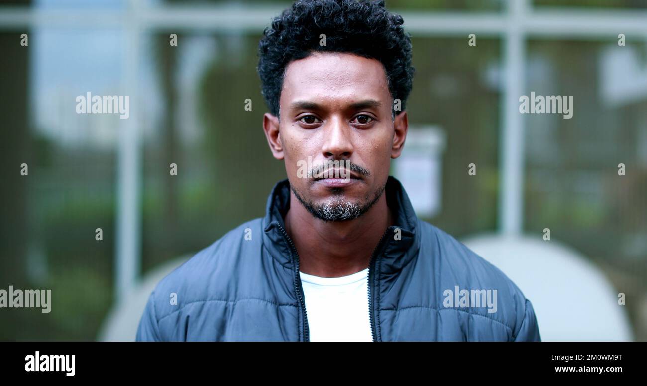 Confident black person walking towards camera Stock Photo - Alamy