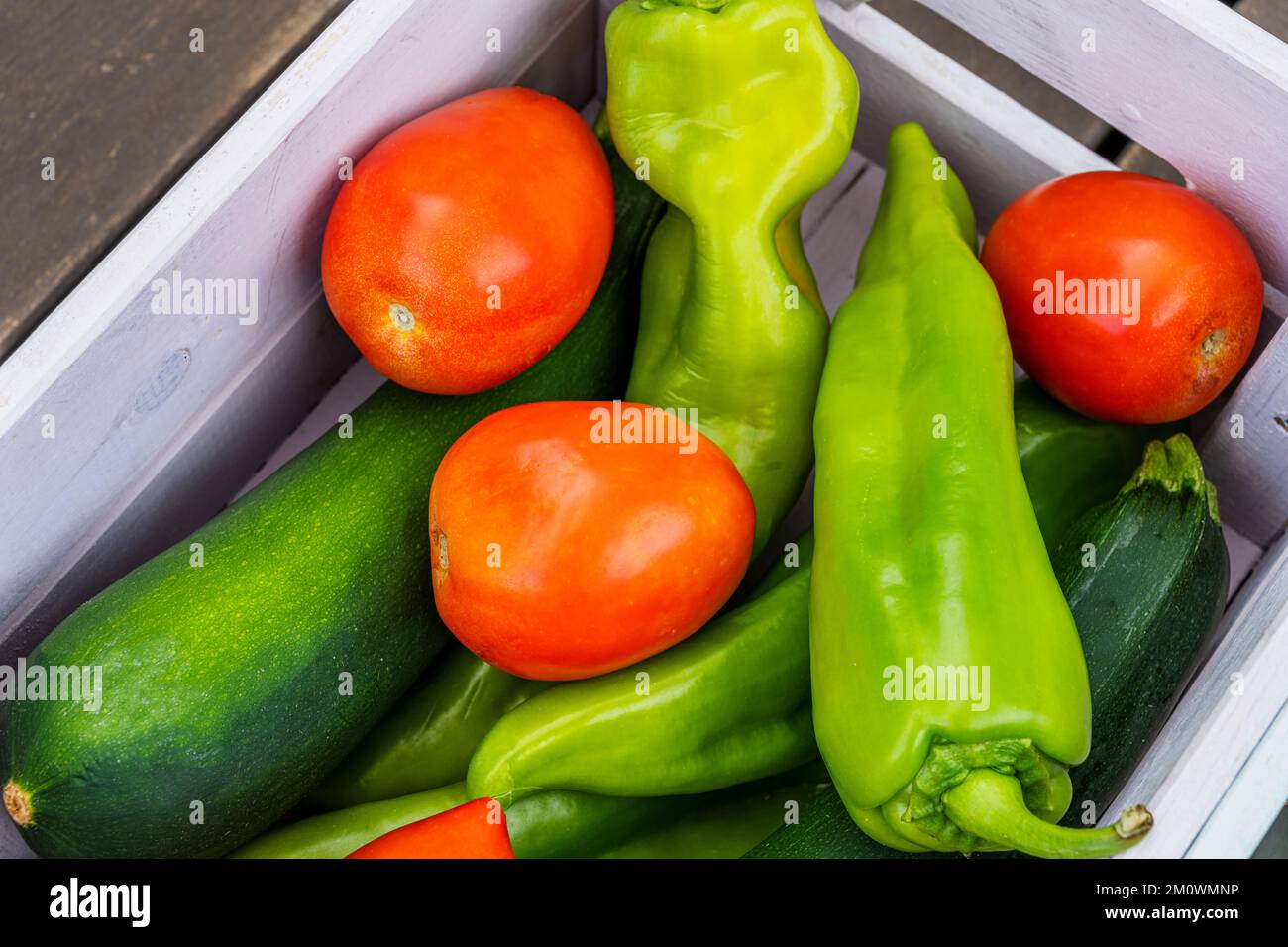 Some fresh fruits and tomatoes with Italian green peppers inside a ...
