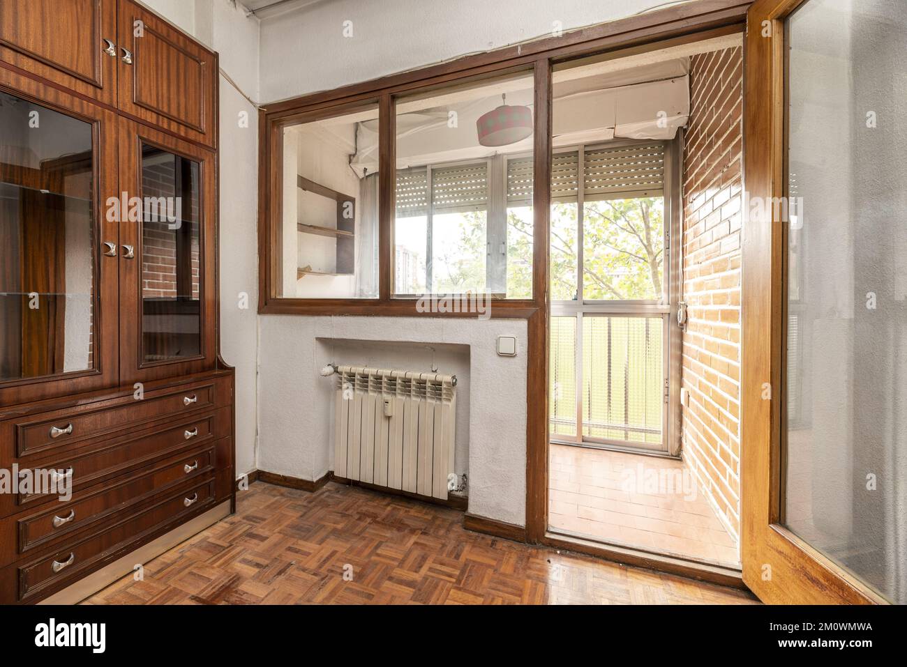 Living room of a house with old and ugly style wooden furniture and ...