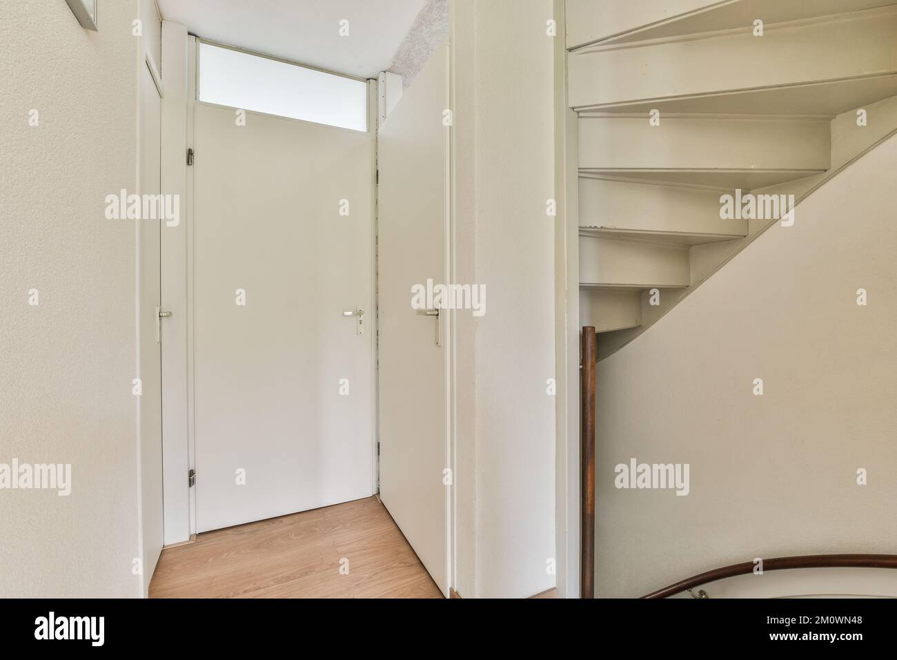 White hallway with stairway leading to second floor of modern apartment ...