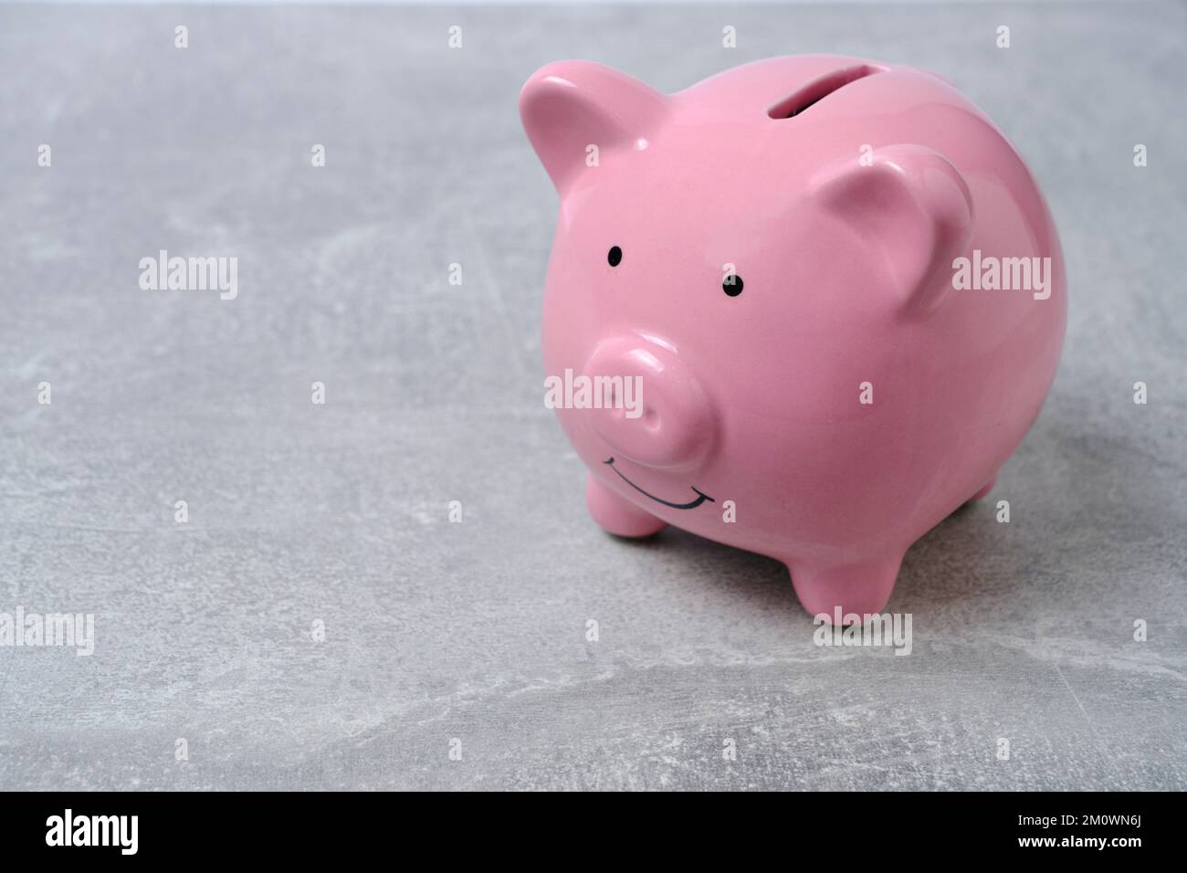 Pink piggy bank light concrete background Stock Photo - Alamy