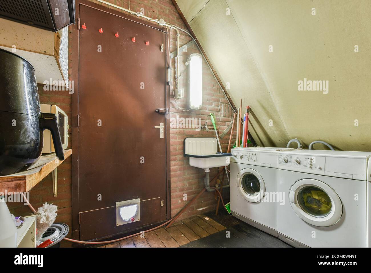 Spacious garage with closed door and garden tools to take care of ...