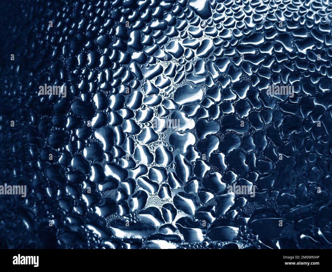 Glass with raindrops on blue tone background. Abstract ultramarine wet ...