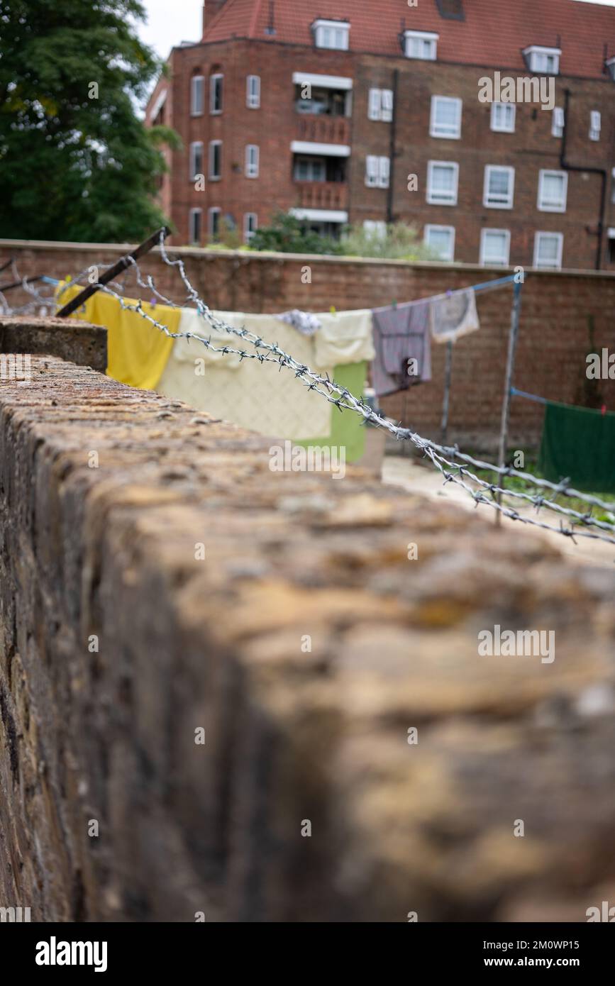 Council estate in south London with wall and barbed wire Stock Photo ...