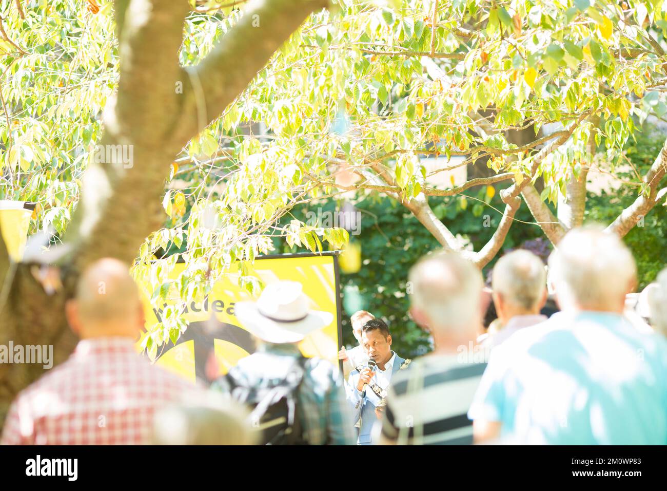 Mayor of Camden, Cllr Nasim Ali, speaks near the cherry tree planted in ...
