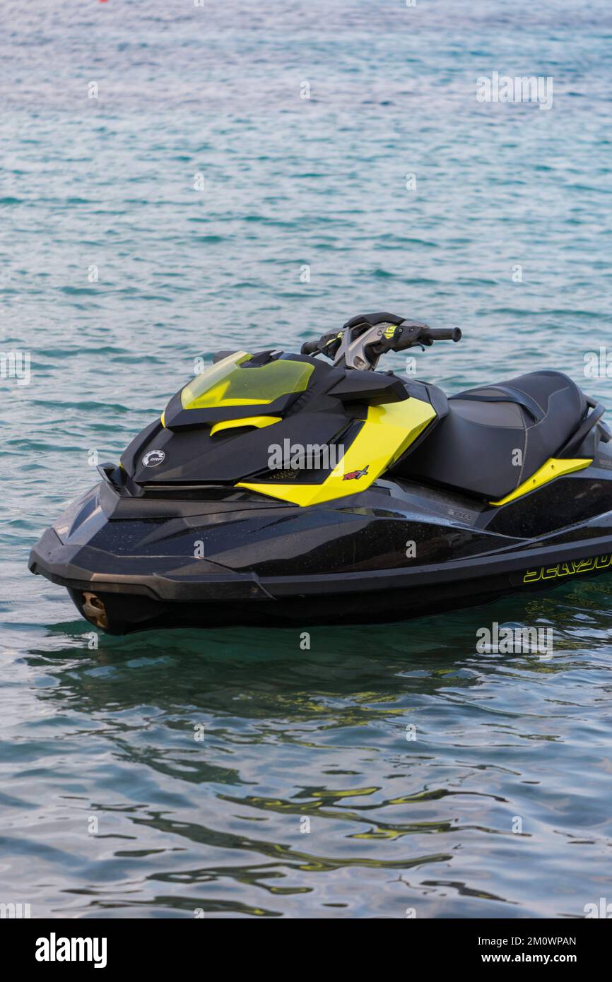 A vertical shot of the black and yellow jet sky in the sea during the ...