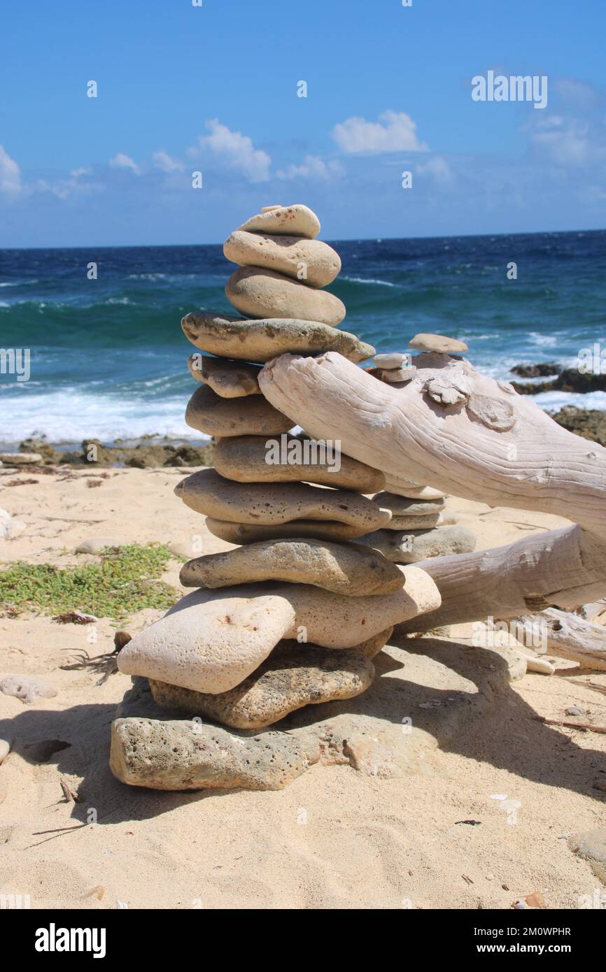 A vertical shot of some rocks on top of each other at a beach in ...