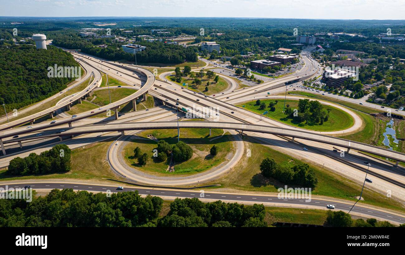 A bird's eye view of cars passing by highway road intersection in shape ...