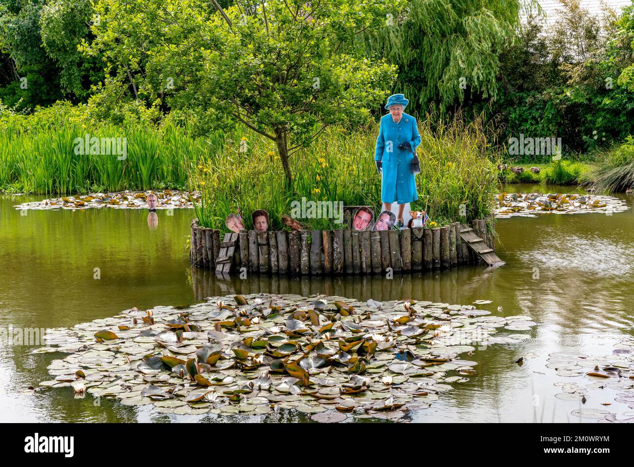 A Figure Of Queen Elizabeth II Surrounded By Her Family Appears On An ...