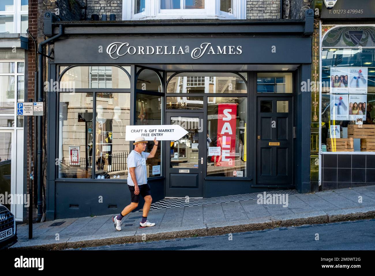 A Man Walks Up Lewes High Street With An Advertising Sign, Lewes, East ...