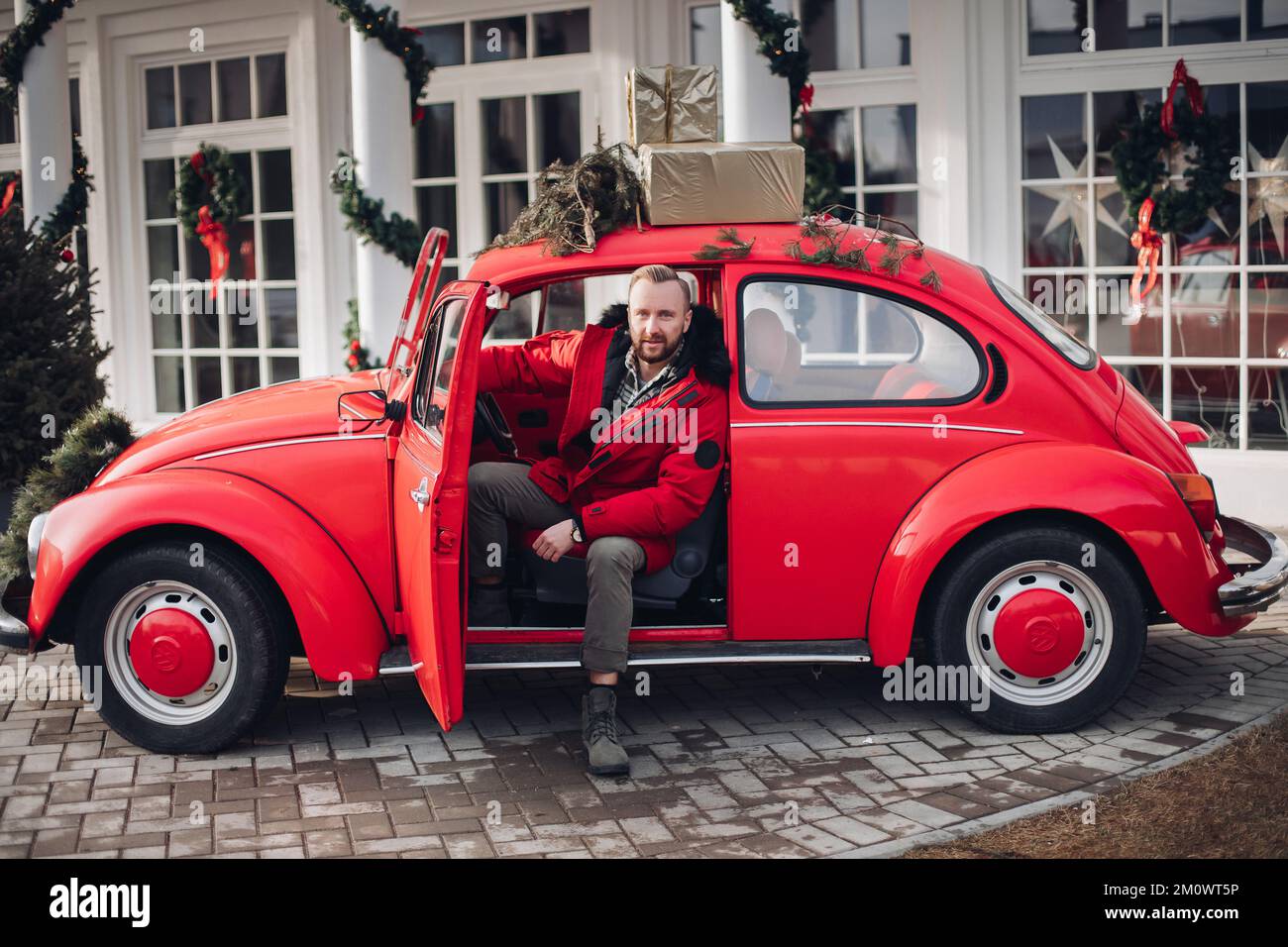 Stylish man in red in vintage car Stock Photo - Alamy