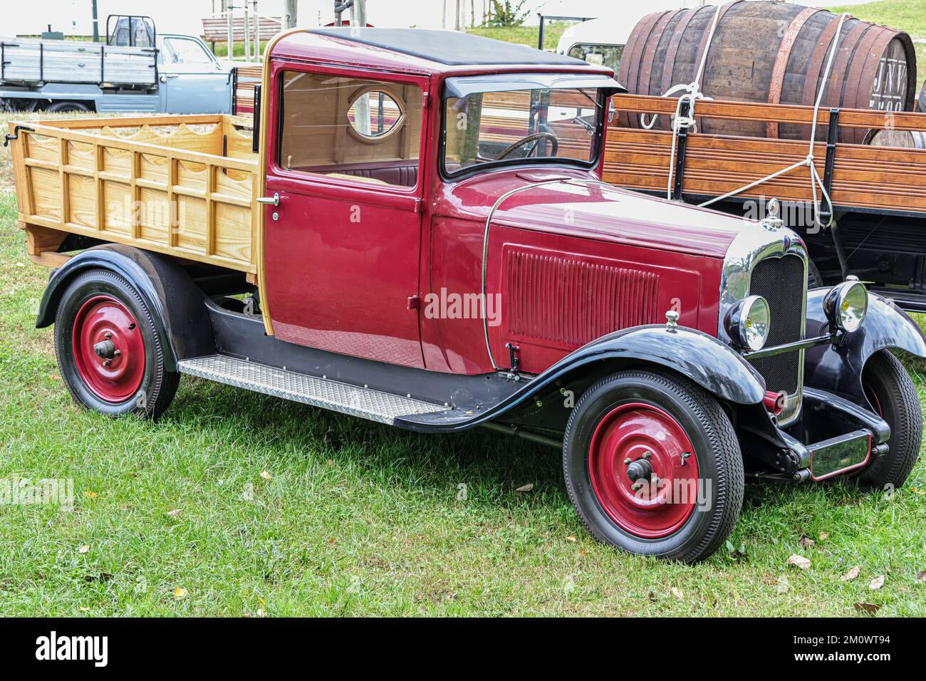 A side view of a beautiful red Citroen b14 classic pickup track with a ...