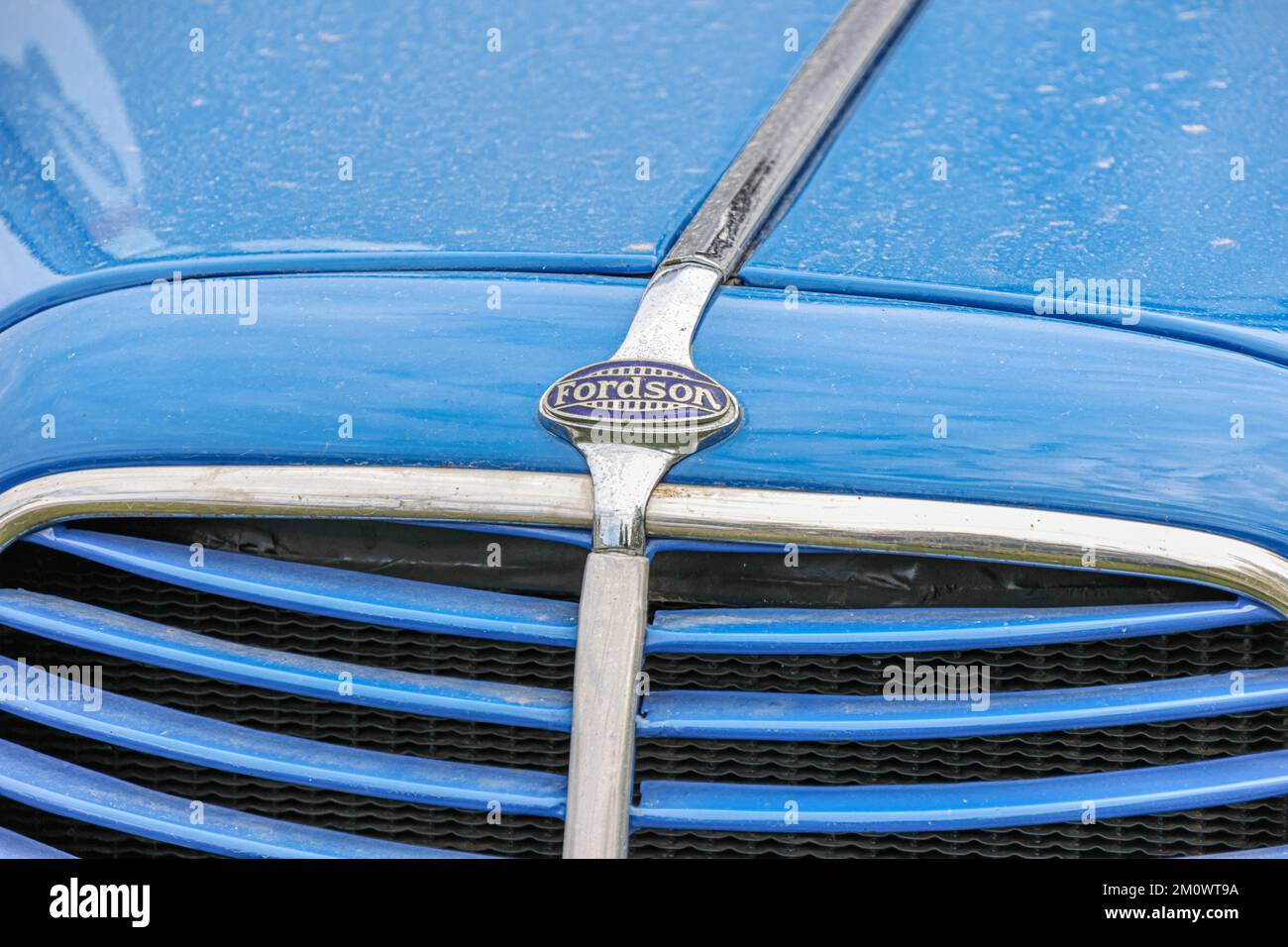 A closeup of the Fordson logo on the hood of a beautiful blue Fordson ...