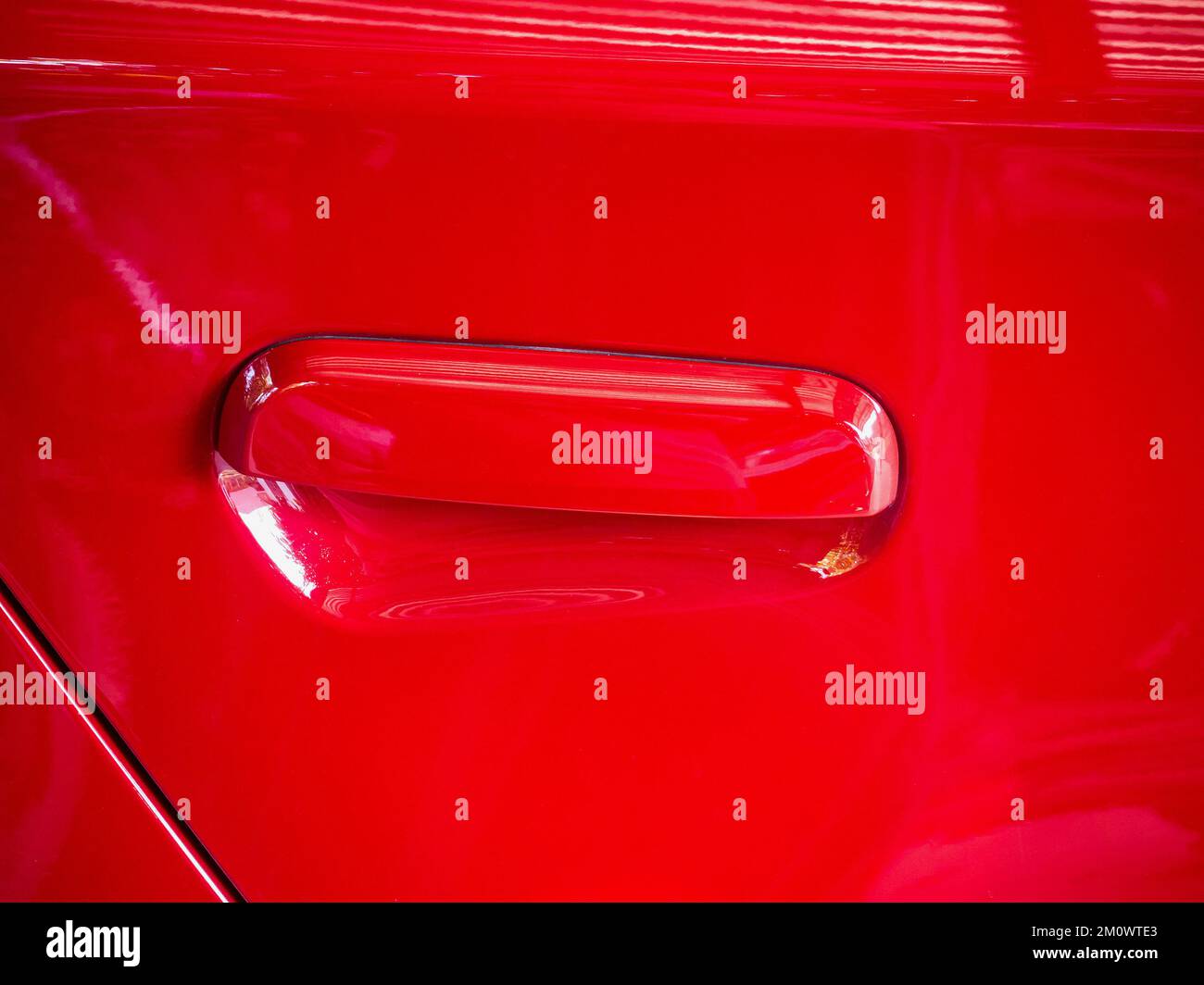 Red car door handle Stock Photo - Alamy