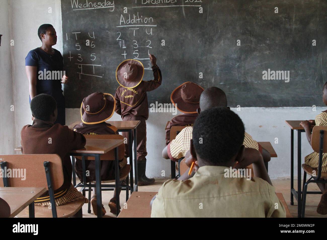 Goromonzi, Zimbabwe. 7th Dec, 2022. A student writes on a black board ...