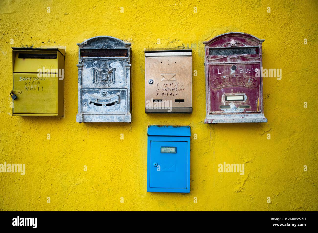 letter boxes on yellow wall Stock Photo - Alamy