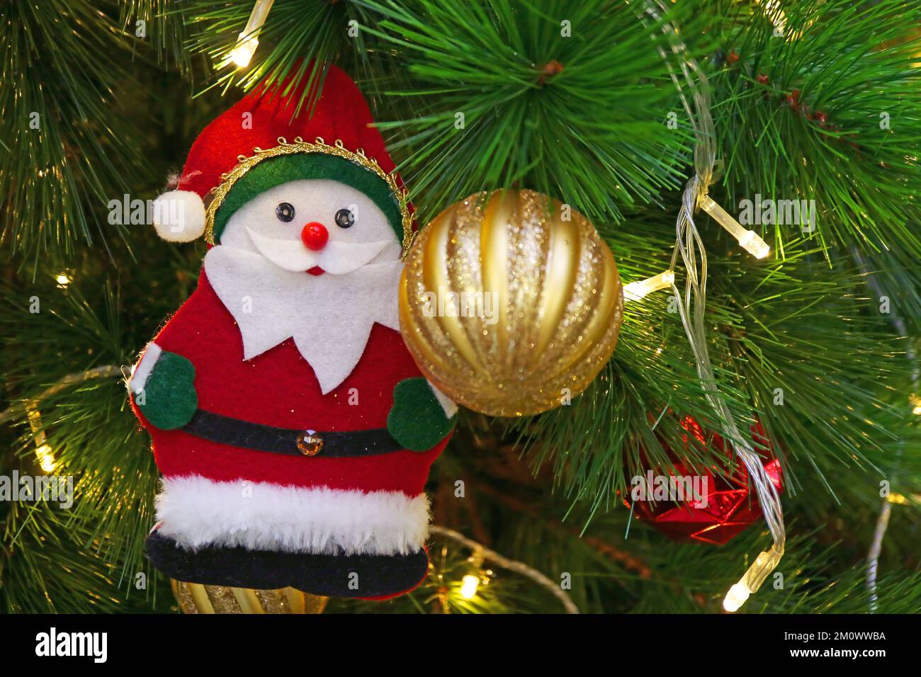 Santa Claus with Golden Ball Ornament Hanging on a Glittering Christmas ...