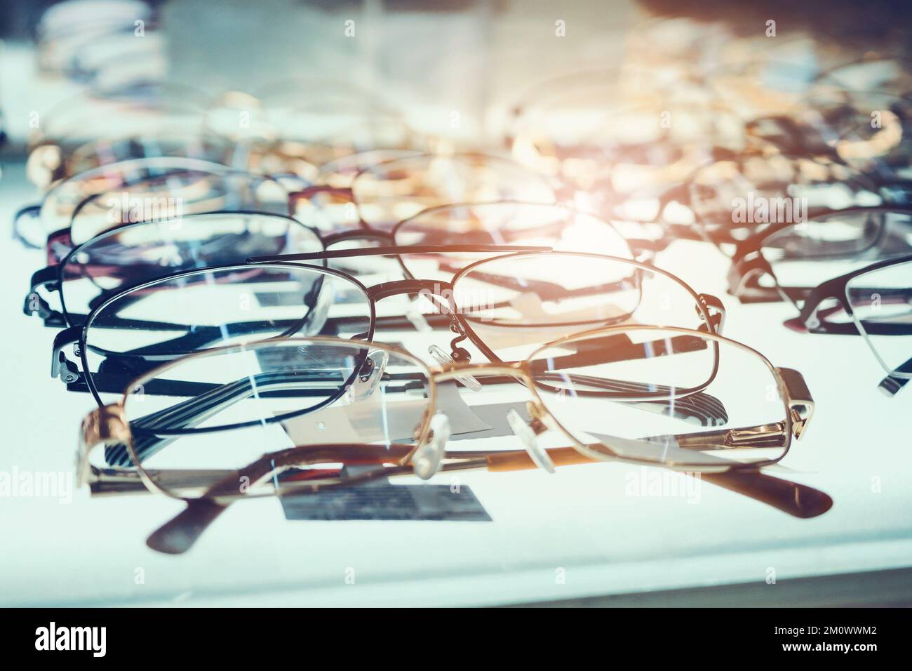 Eye glasses on window display shelves in optics store Stock Photo - Alamy