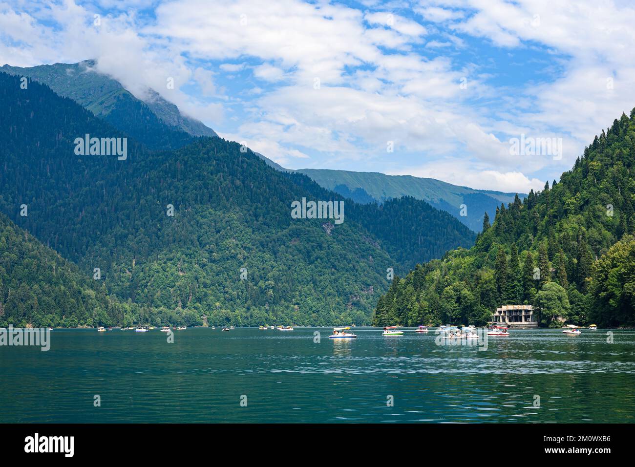 Mountain steep hills with green forests surround Lake Ritsa Stock Photo ...