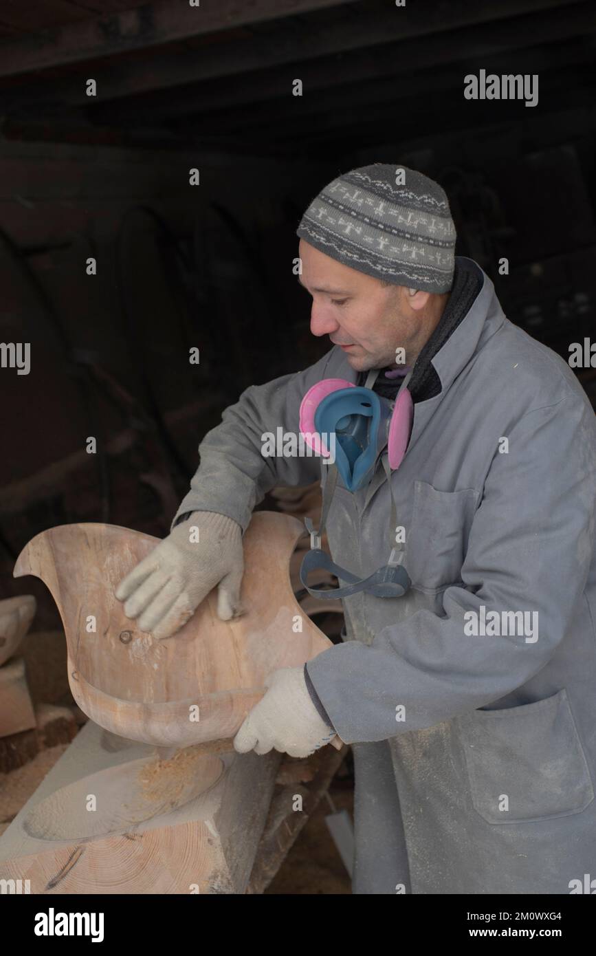 craftsman carves the plates out of wood by hand. The Art of the ...