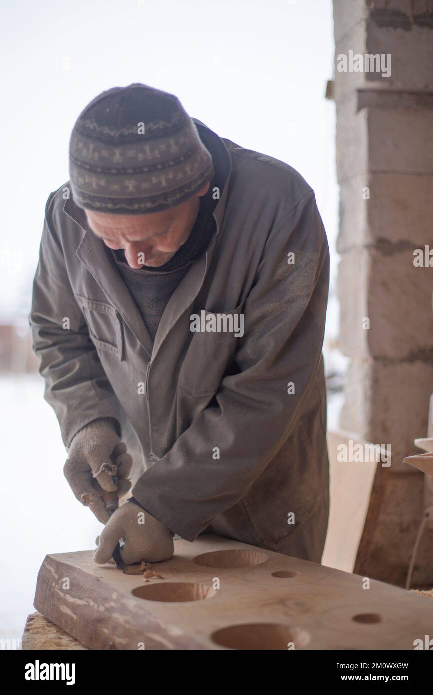 craftsman carves the plates out of wood by hand. The Art of the ...