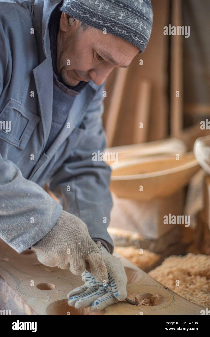 craftsman carves the plates out of wood by hand. The Art of the ...