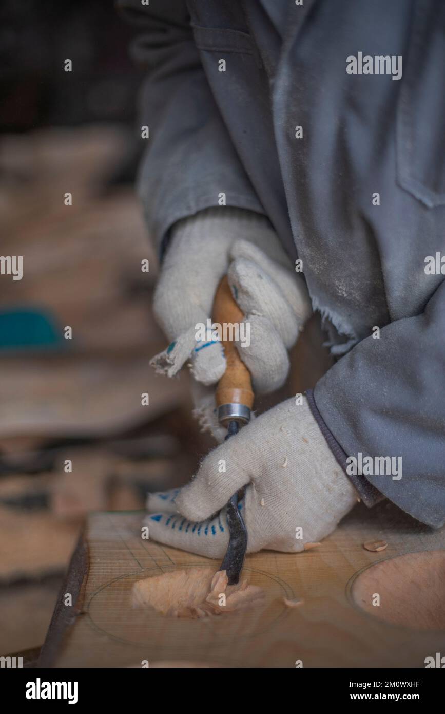 craftsman carves the plates out of wood by hand. The Art of the ...