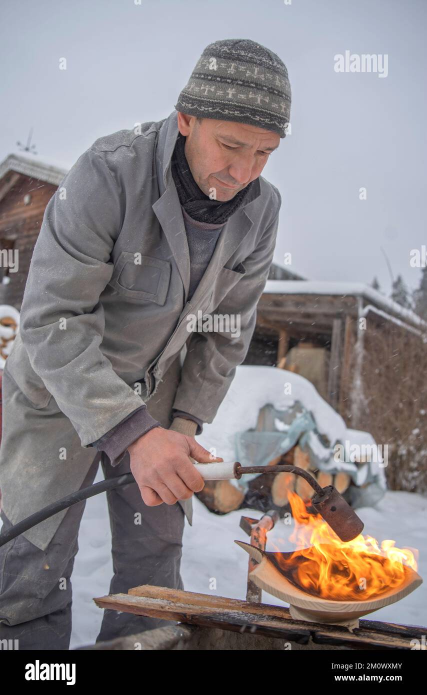 decorative burning of wood with a burner. wood artist Stock Photo - Alamy