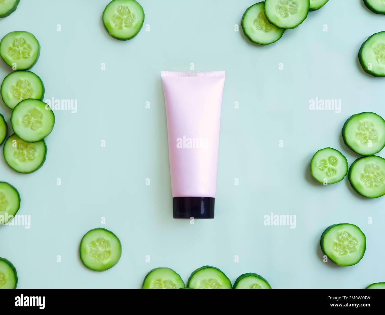 Pink squeeze bottle cosmetic tube with black cap and fresh sliced ...