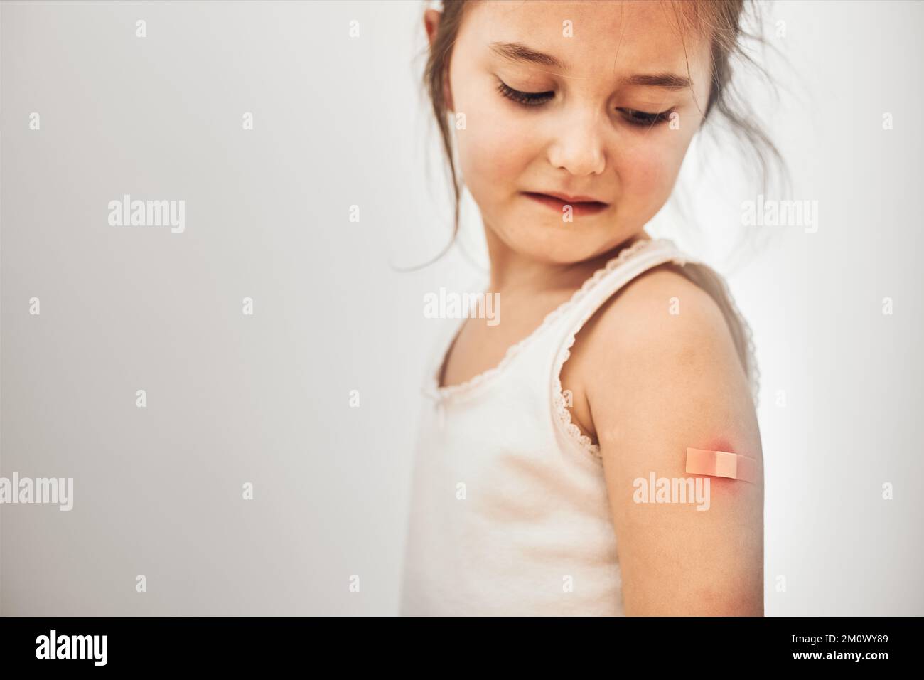 Little girl feeling pain having some side effects after vaccination ...