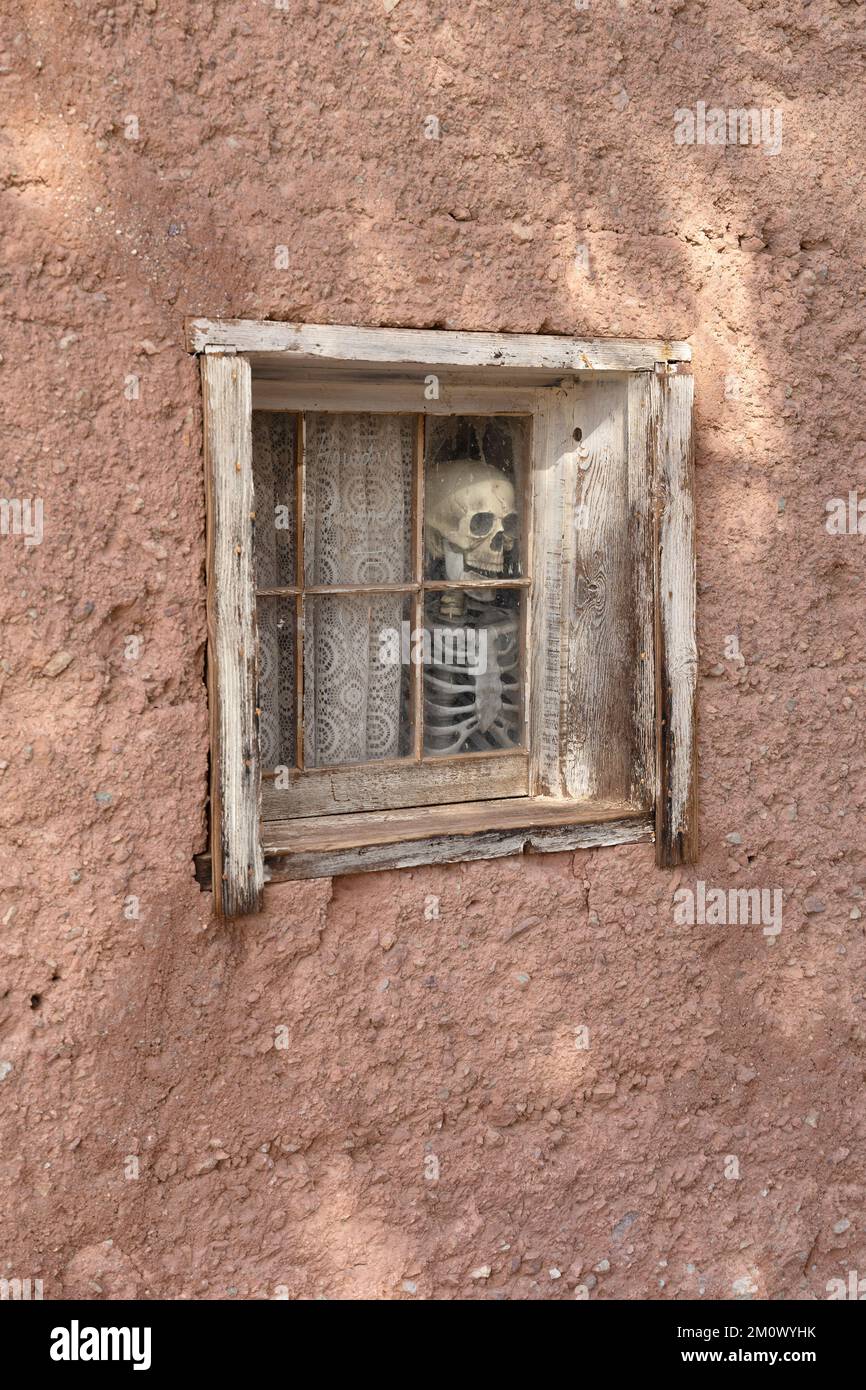 A skeleton looks out a window of an old building Stock Photo - Alamy