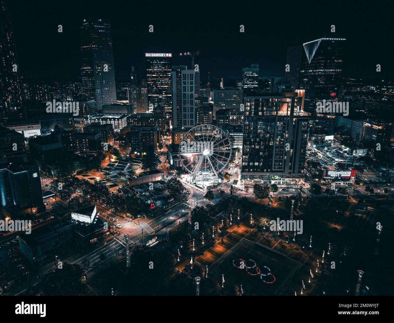 Aerial view of illuminated skyscrapers, ferris wheel and buildings at ...