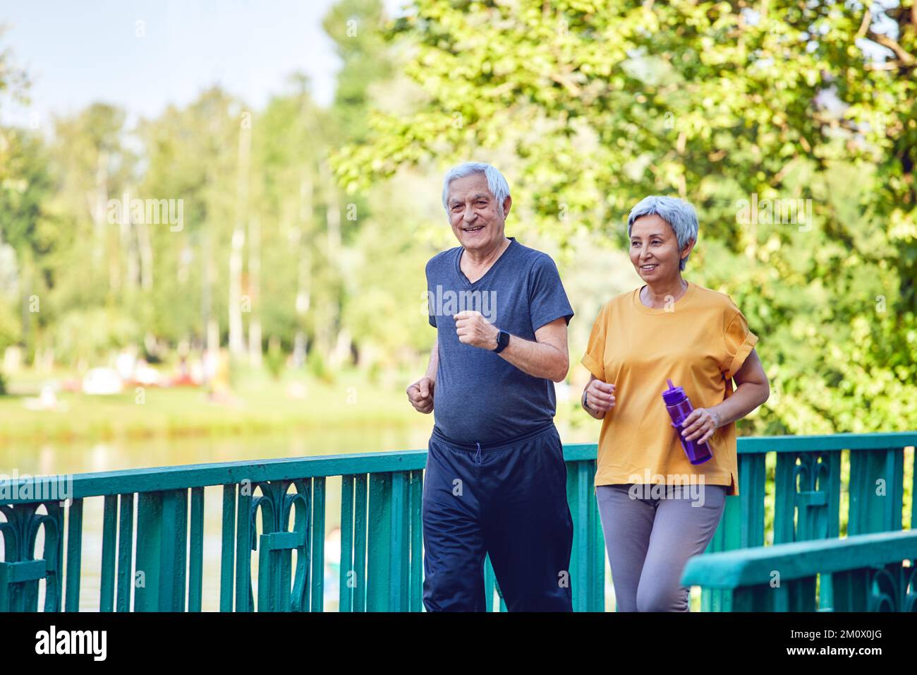 Asian and Caucasian middle-aged wife and husband wear activewear ...