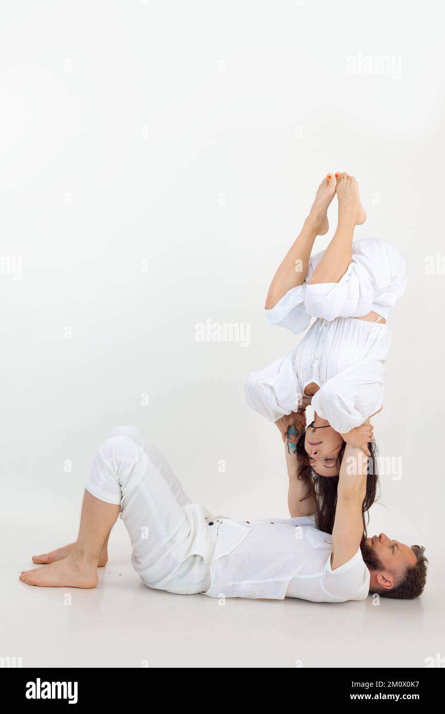 Sporty family on white background. Middle-aged man lying holding young ...