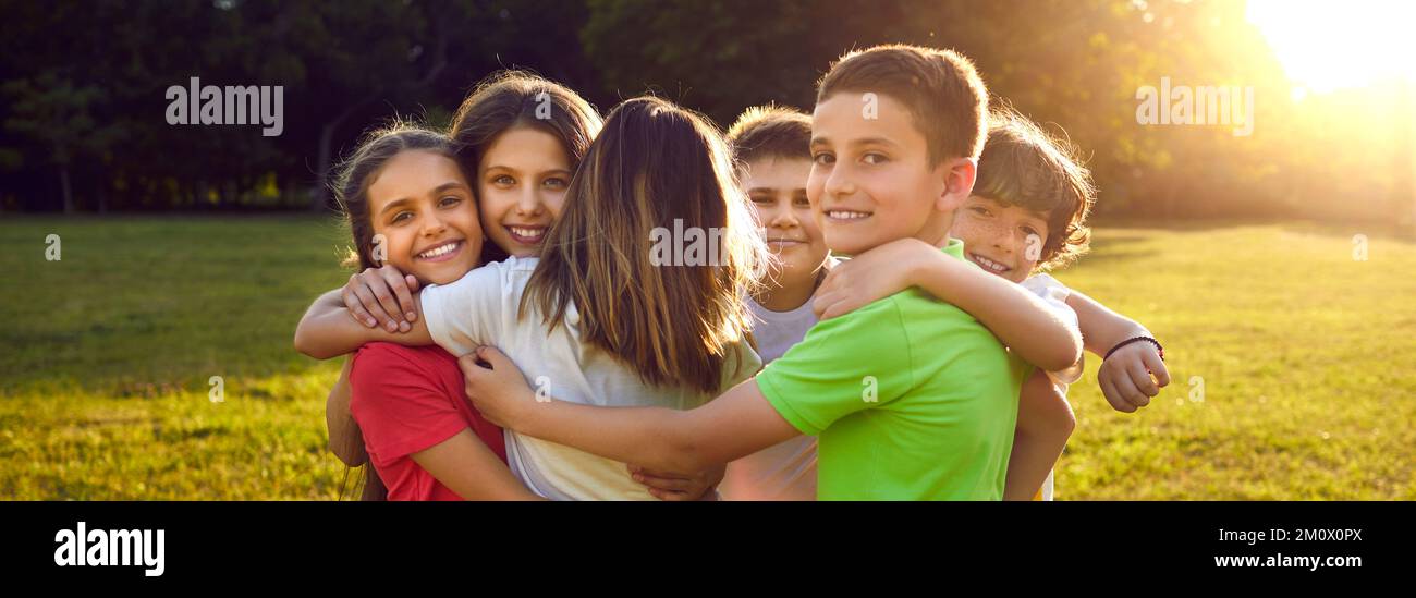Group of happy little children hugging each other while having fun in ...