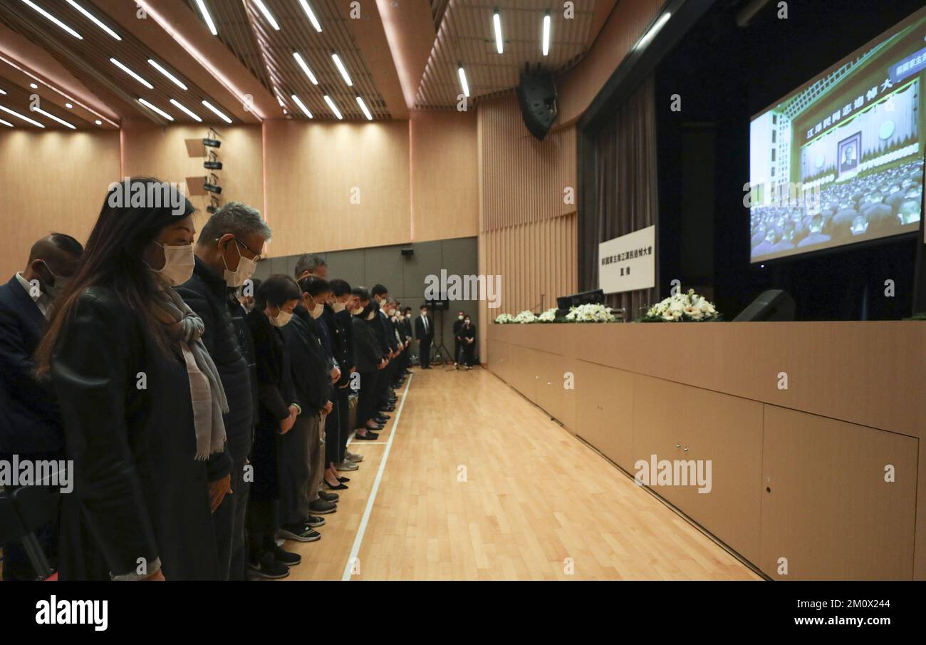 People watch the broadcast of former President Jiang Zemin's funeral at ...