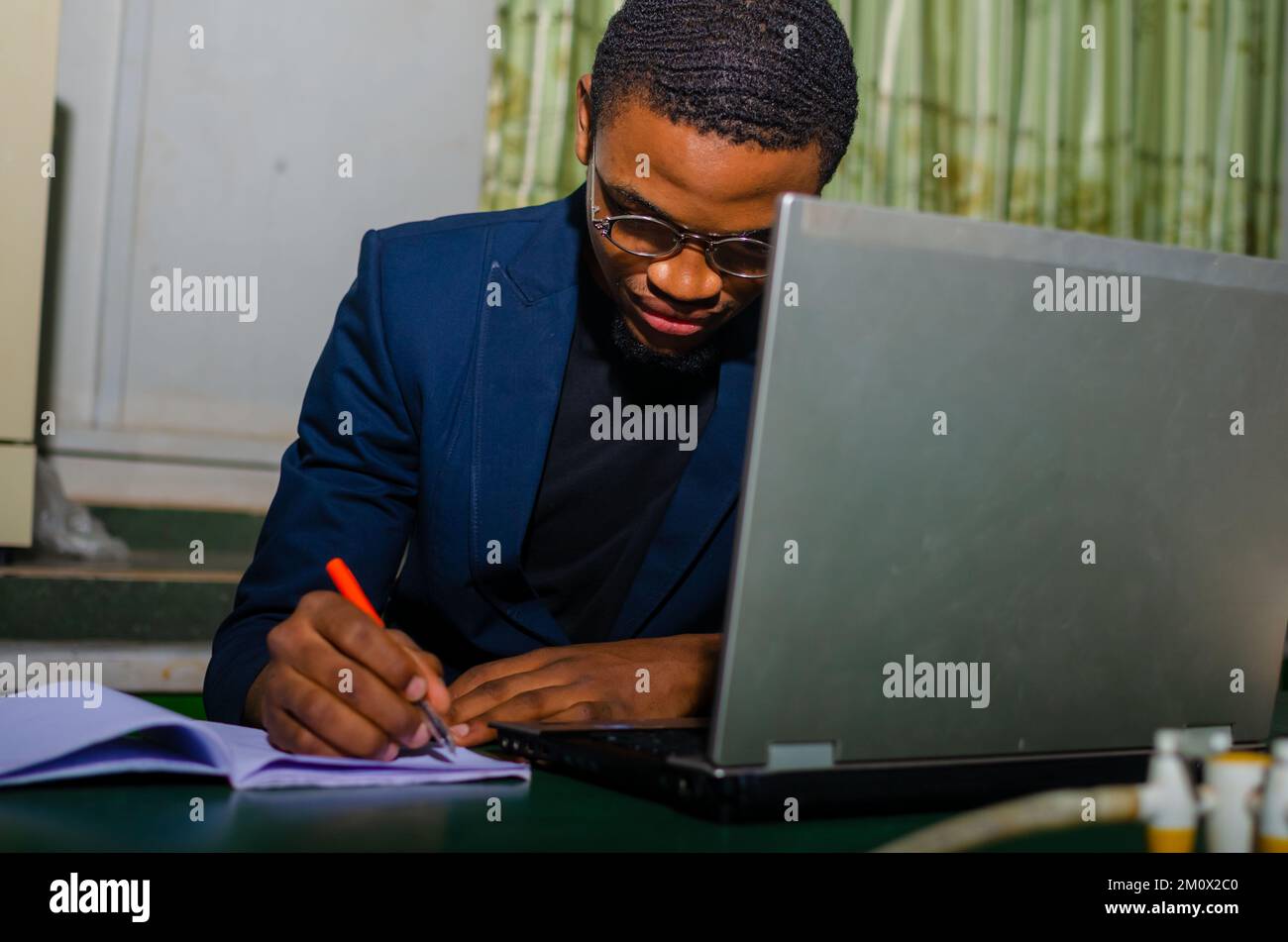 The pharmacist reviewing the list of drugs and checking the stock of ...