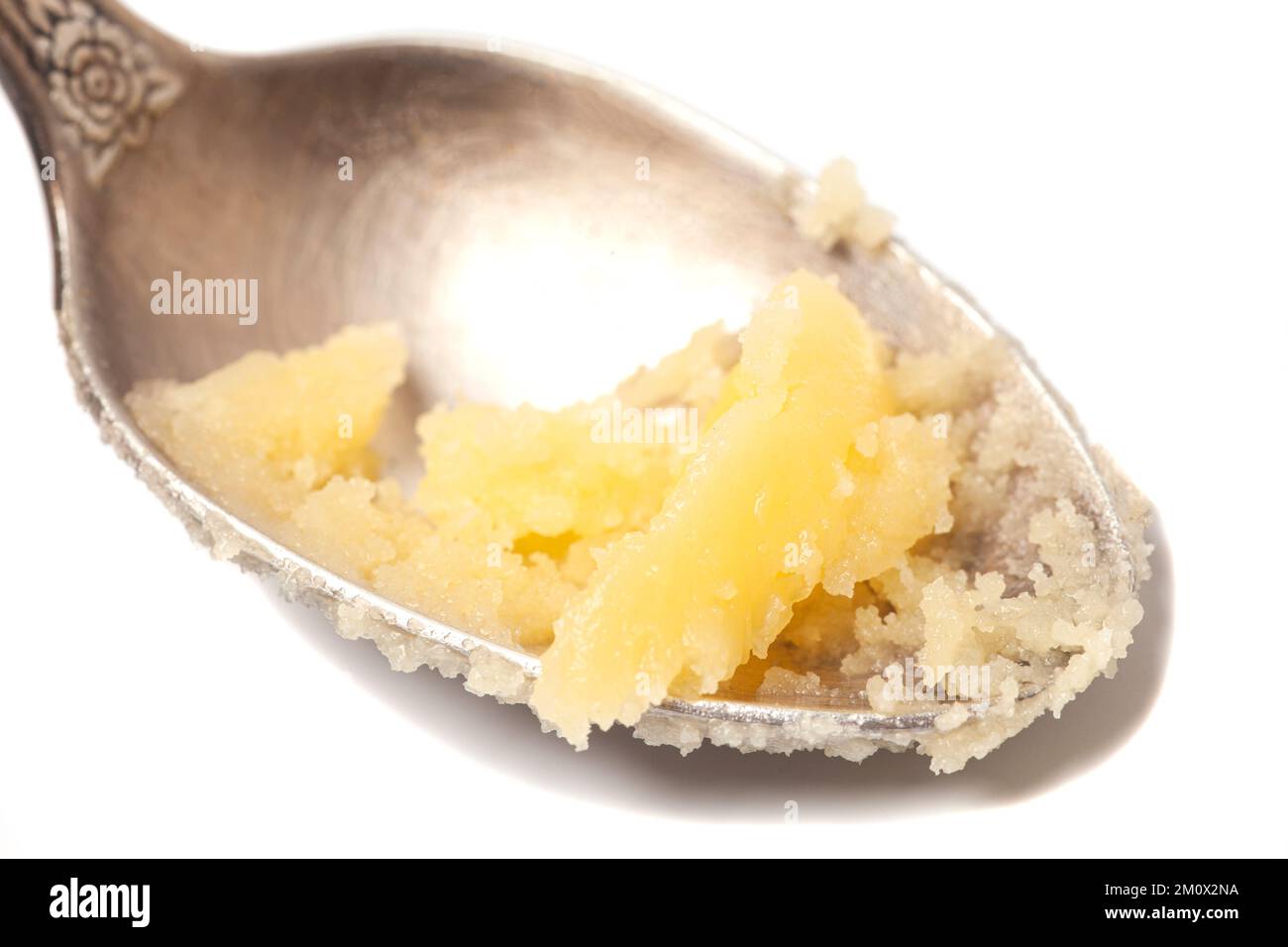 Ghee in spoon isolated on white background Stock Photo - Alamy