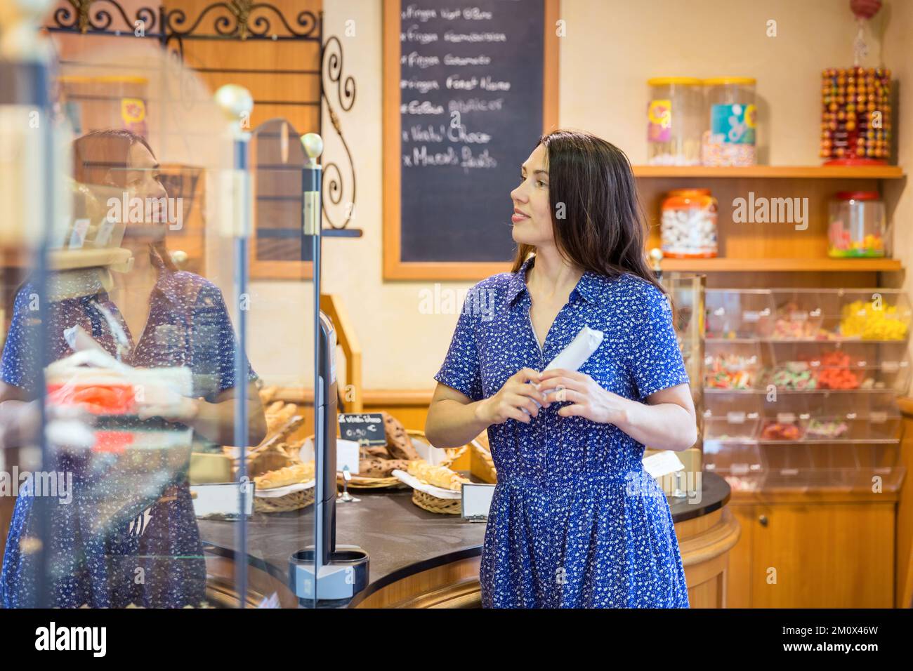 Young pretty woman shopping in a bakery Stock Photo - Alamy