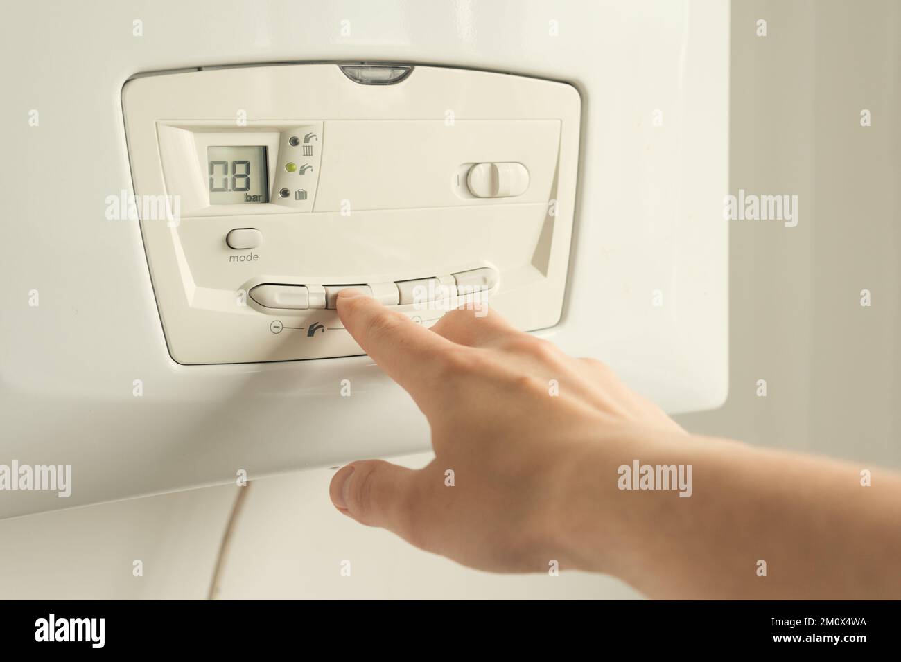 Man setting temperature on a heating boiler construction Stock Photo ...