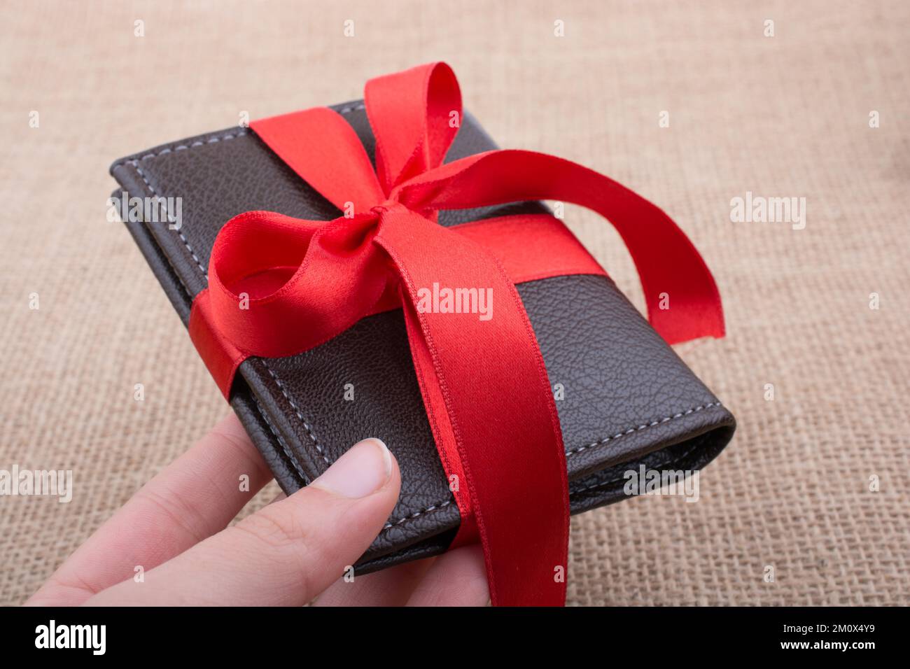 Brown color ribbon onbrown linen canvas Stock Photo - Alamy