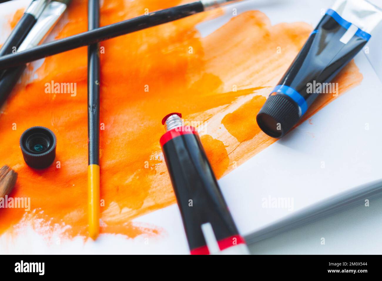 Artist's workplace. Paint and brushes on canvas. Artist workflow ...